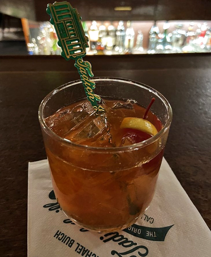 That Old Fashioned isn't just a cocktail; it's a time machine in a glass, complete with the restaurant's signature swizzle stick.