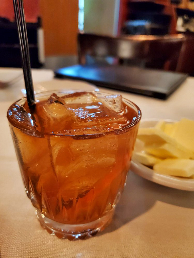 An Old Fashioned sitting pretty on white linen&mdash;because sometimes the perfect cocktail is the one that's stood the test of time. 