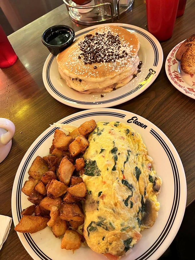 A proper diner omelet: fluffy, generous, and paired with perfectly crisped potatoes. Morning salvation on a plate with the Eleven logo.