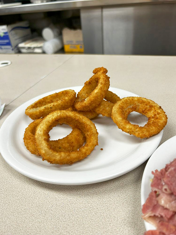 These golden onion rings aren't just side dishes &ndash; they're crispy halos celebrating your excellent decision to visit Slyman's today.