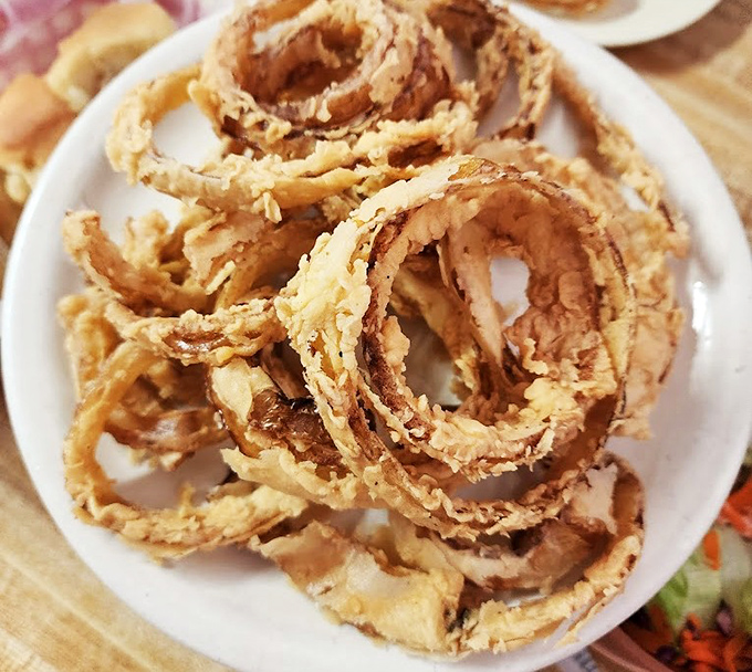 Onion rings that achieve that mythical balance - substantial enough to satisfy yet light enough to make you reach for "just one more" until they're gone.