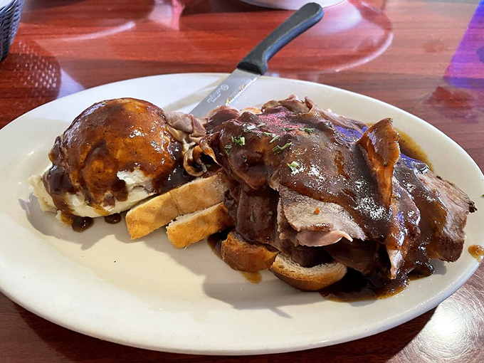 Open-faced roast beef sandwich with gravy &ndash; comfort food that hugs your soul while simultaneously plotting against your belt size.