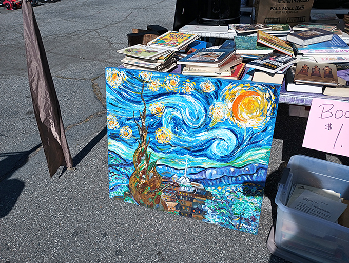 A Starry Night replica leans casually against stacks of books, proving Van Gogh's swirls look just as mesmerizing in a parking lot as in a museum.