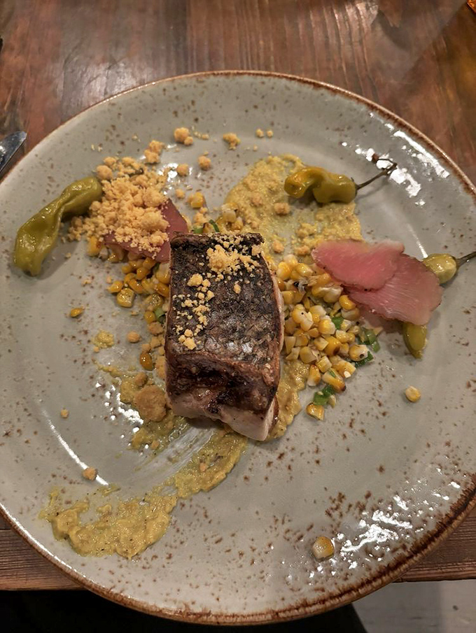 Fish that's been introduced to heat at precisely the right moment. The corn and pepper accompaniments create a plate that's both elegant and comforting.