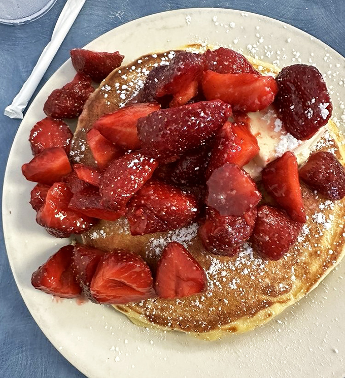 These pancakes, crowned with fresh strawberries and a dusting of powdered sugar, aren't just breakfast &ndash; they're edible sunshine on a plate.
