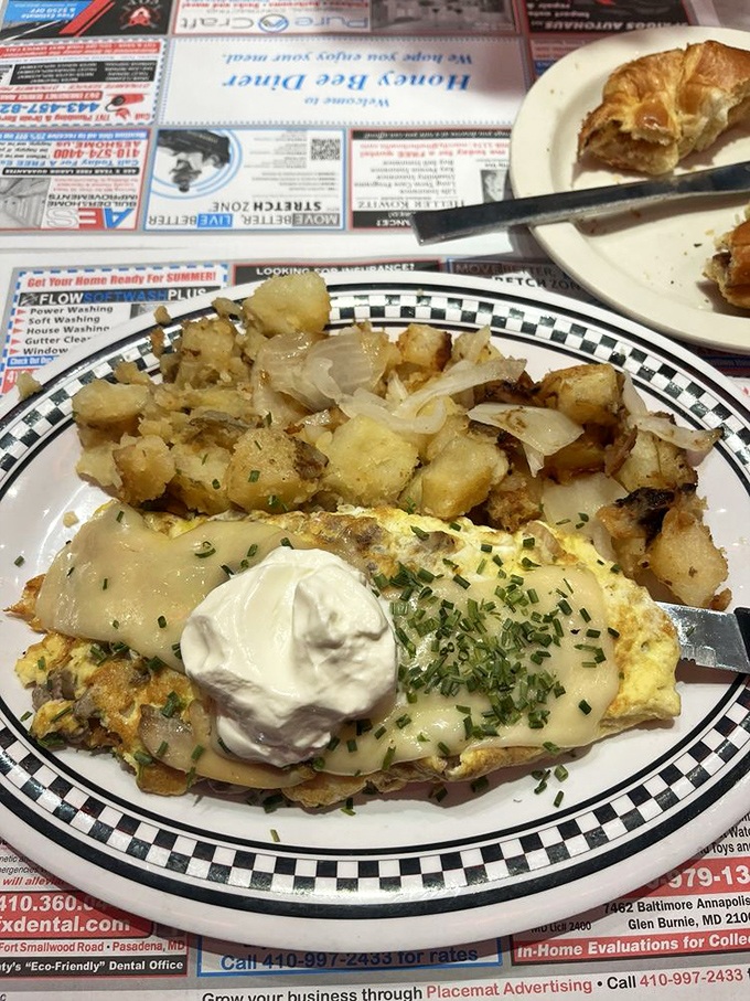 An omelet that's dressed better than most of us&mdash;draped in cheese, topped with sour cream, and accessorized with crispy potatoes.