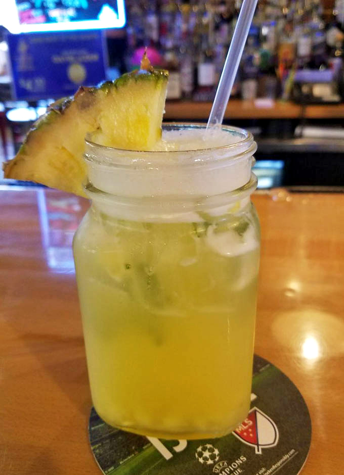 That pineapple coconut mojito looks like vacation in a glass &ndash; tropical escape meets Philadelphia barbecue joint perfection.