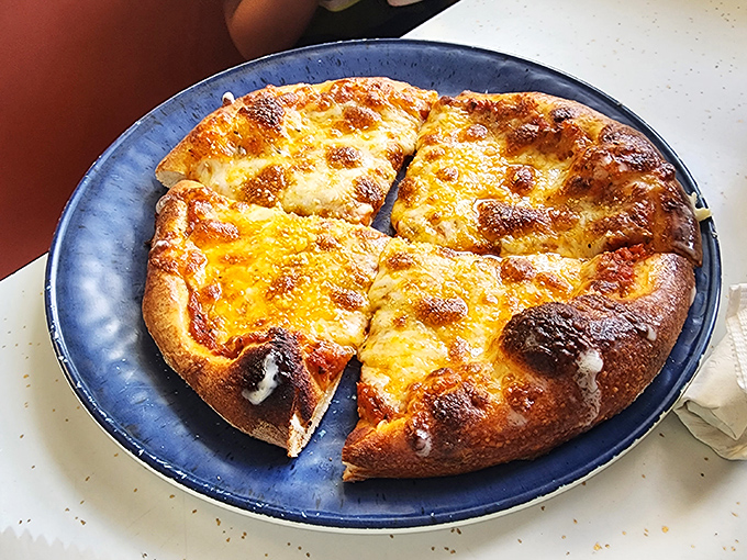Pizza that reminds you why simple pleasures endure &ndash; a perfectly browned crust supporting a blanket of melted cheese that stretches for days.