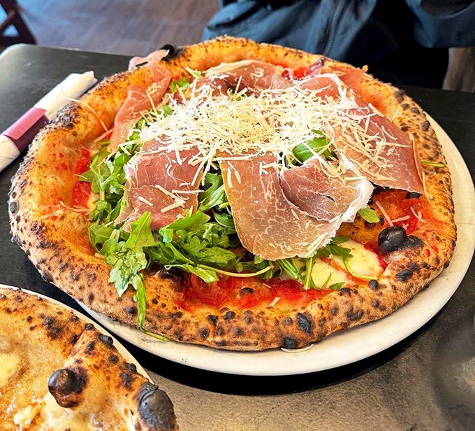 Fresh arugula and prosciutto atop a pizza isn't just a topping strategy&mdash;it's a philosophy that says "salad and pizza can live on the same plate."