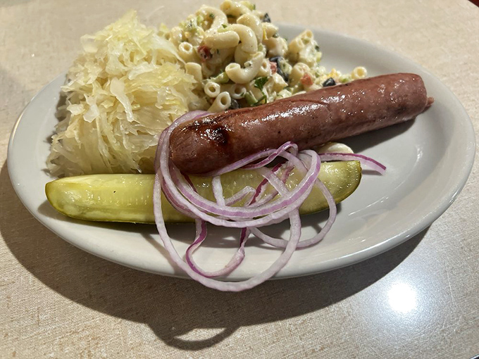 Polish sausage with sauerkraut and pasta salad&mdash;proof that Carshon's understands the art of the plate lunch. That pickle and red onion garnish seals the deal.
