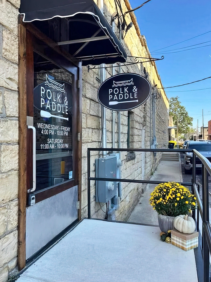 Polk & Paddle's stone facade and seasonal decor create the kind of welcoming entrance that makes you feel like a regular on your first visit.