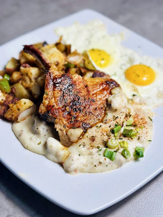Sunshine on a plate: golden scrambled eggs, seasoned potatoes, and a burger patty that means business.