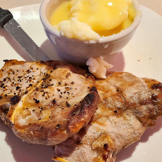 Pork chops that have clearly been introduced to fire with proper respect. That side of applesauce isn't just tradition&mdash;it's the law.