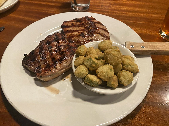 A perfectly grilled pork ribeye with those crispy fried okra nuggets&mdash;proof that sometimes the simplest preparations yield the most satisfying results.