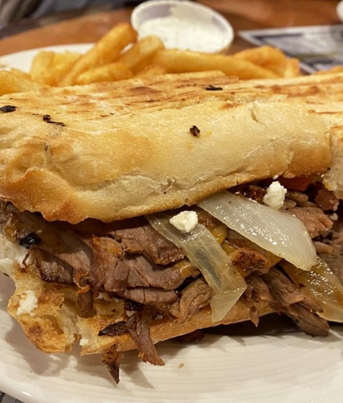 When a sandwich requires structural engineering&mdash;tender pot roast, caramelized onions, and melty cheese creating the comfort food equivalent of a warm hug.