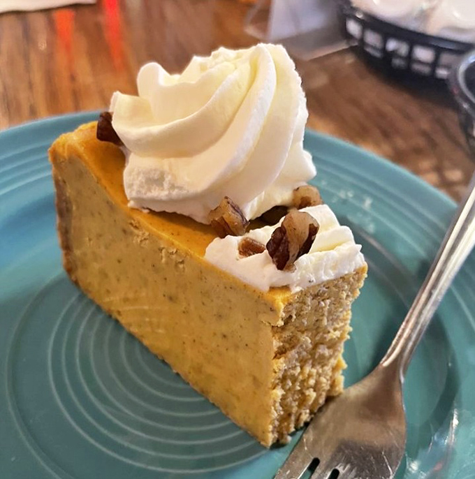 Pumpkin cheesecake that would make grandmothers weep with joy. That dollop of whipped cream isn't decoration—it's the perfect dance partner.
