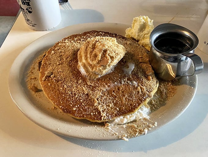 A pancake so perfect it deserves its own zip code. That dollop of butter creating a golden pool is nature's perfect sauce delivery system.