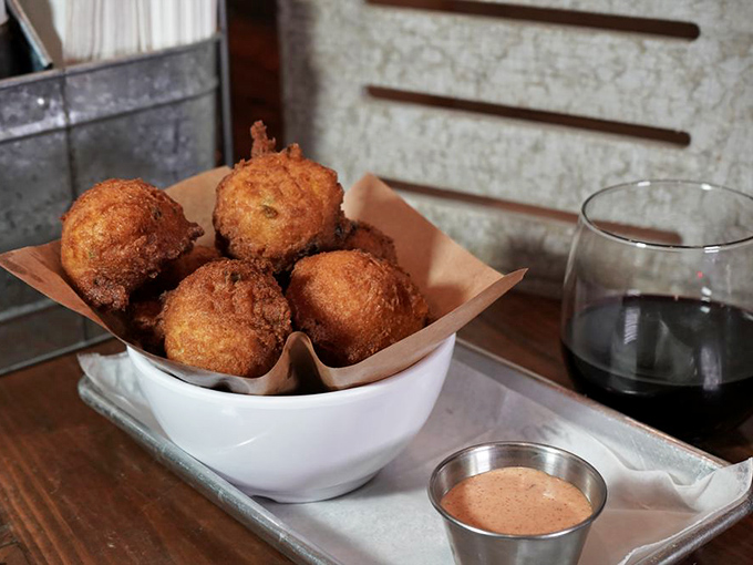 Hush puppies that crackle with golden perfection, served with a sauce that demands repeat dipping.