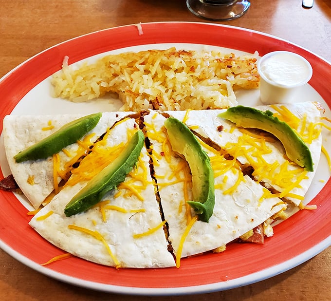 A quesadilla that brings Southwestern flair to Montana mornings, with avocado slices adding creamy contrast to the melted cheese and crispy exterior.