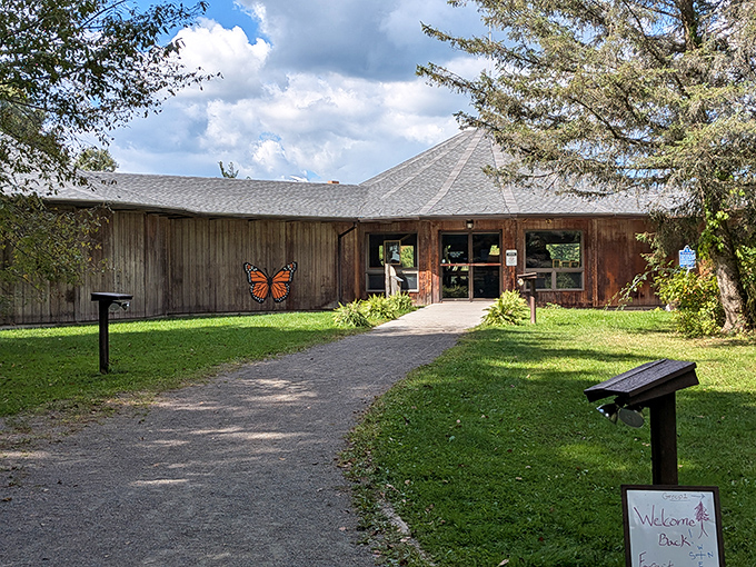 The Cumming Nature Center welcomes visitors with rustic charm and a giant butterfly, nature's way of saying "the WiFi signal might be weak, but the experience is strong."