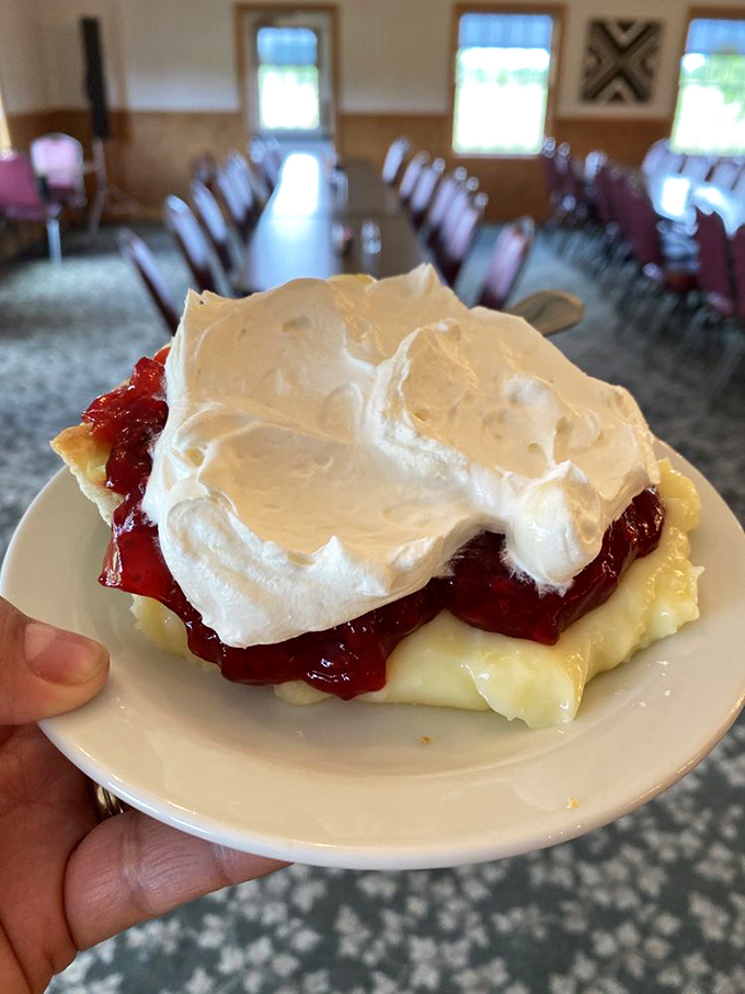 Raspberry cream pie topped with meringue peaks that would make any baker weep with joy and any dieter reconsider their choices.