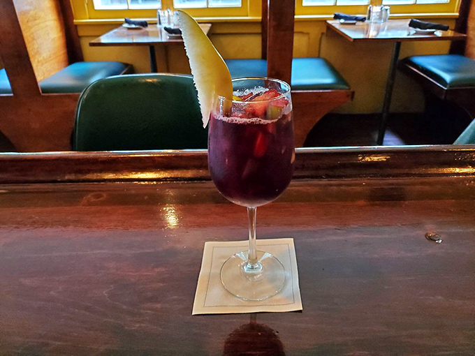 A sangria garnished with apple slice &ndash; because sometimes your wine deserves to wear a jaunty hat too.
