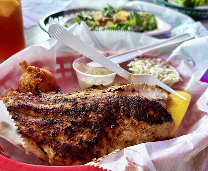 Blackened to perfection, this fish filet wears its seasoning like a badge of honor. The coleslaw side isn't just an afterthought&mdash;it's a cooling counterpoint.