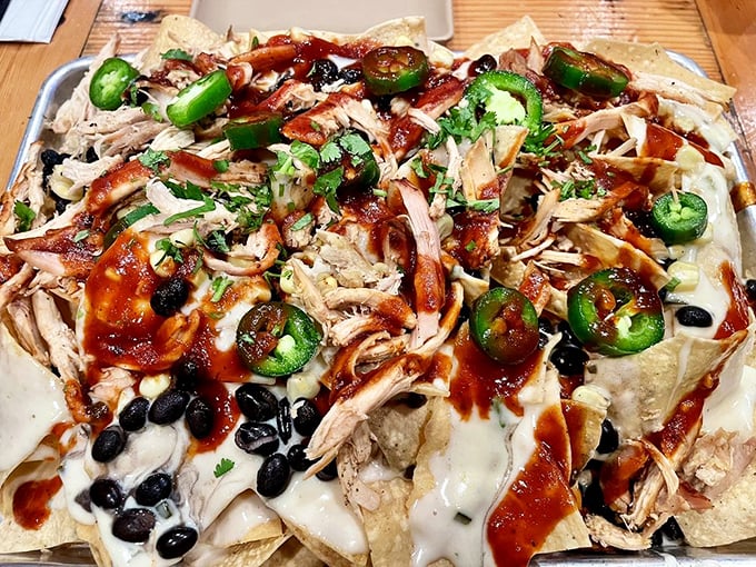Nachos piled so high they need their own zip code, topped with enough pulled pork to feed a small village.