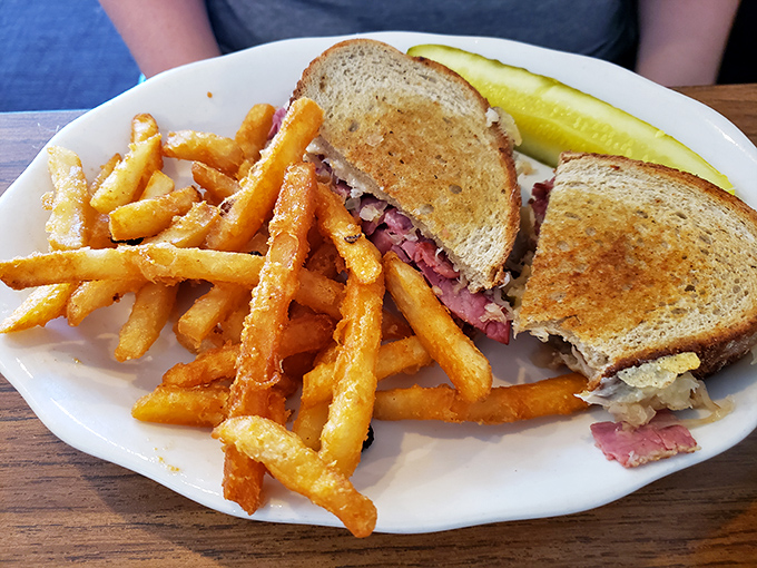 The Reuben at Beacon 443 isn't just a sandwich&mdash;it's architecture. Perfectly grilled rye supporting a skyscraper of corned beef, with those golden fries standing guard like delicious sentinels.