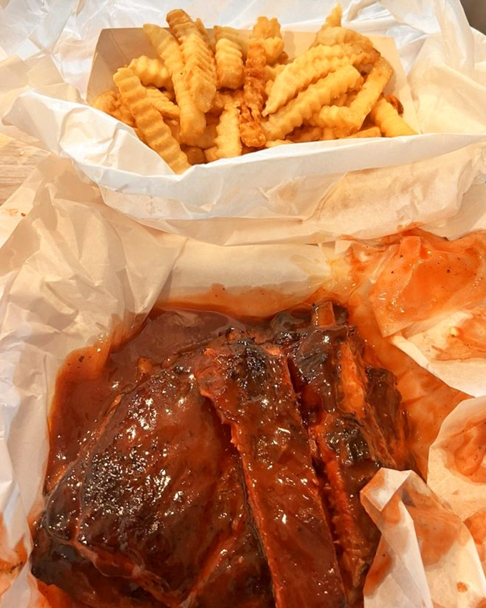 Ribs and fries nestled in paper&mdash;the lunch combo that's launched a thousand napkins. Worth every sauce-stained shirt in history.