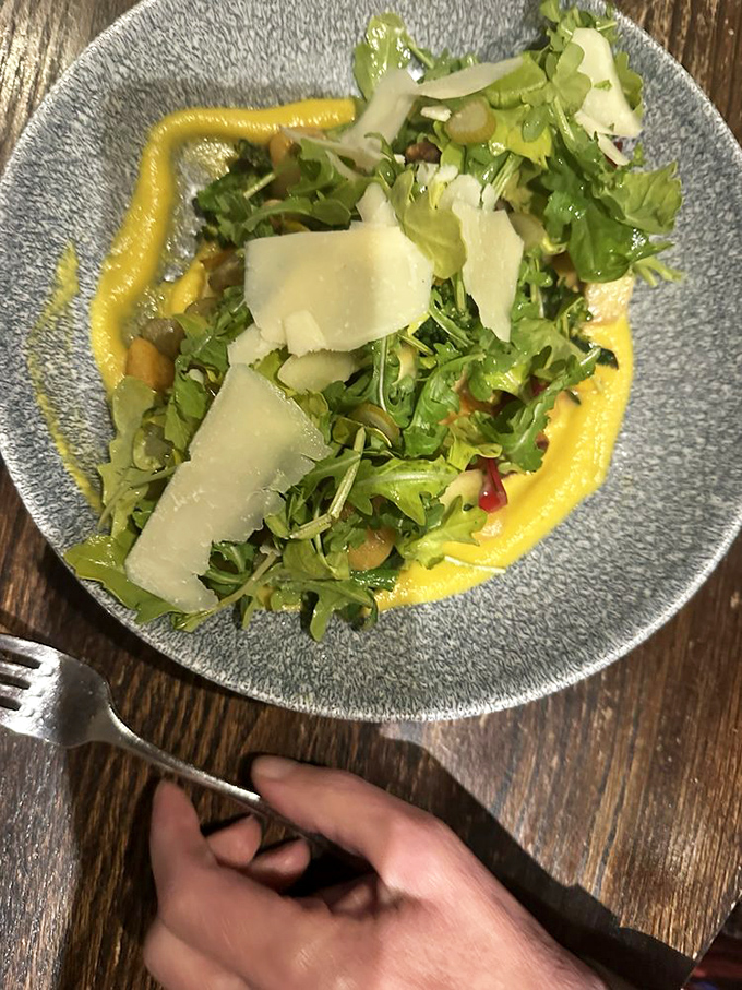 Fresh greens with shaved parmesan on a vibrant sauce&mdash;proof that salads don't have to be punishment between steak dinners.