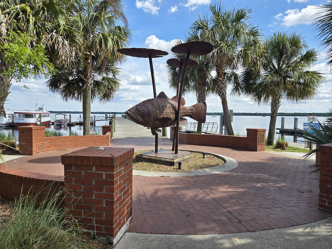 A whimsical fish sculpture watches over the St. Johns River, standing guard where sunsets transform ordinary evenings into postcard-worthy moments.