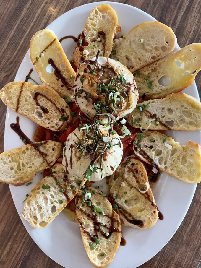 This artful arrangement of burrata with grilled bread isn't just an appetizer; it's edible evidence that simple ingredients treated with respect create magic.
