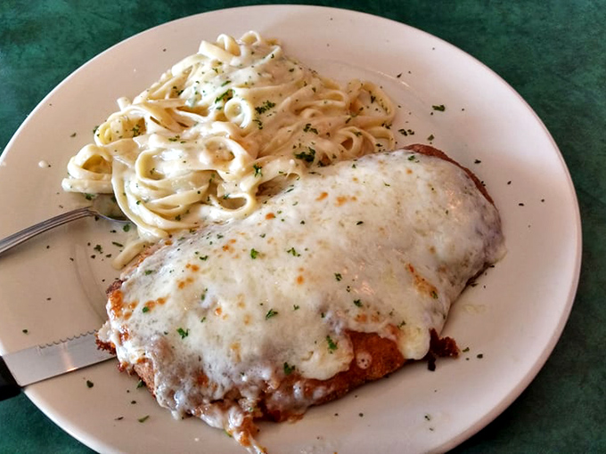 Chicken parmesan with a side of fettuccine that's clearly not counting calories. This plate doesn't just feed your body&mdash;it hugs your soul.