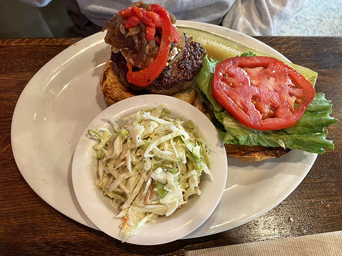The Rustico Burger with caramelized onions and that perfect coleslaw side. A symphony of textures in every bite.