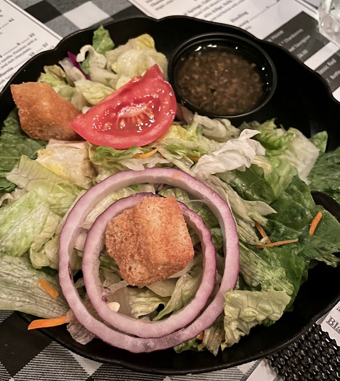 A fresh garden salad that doesn't apologize for being healthy &ndash; those red onion rings are like halos for the virtuous diner preparing for steak indulgence.