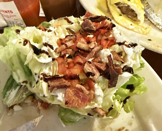 A wedge salad that doesn't apologize for being exactly what it is—crisp, bacon-laden, and unapologetically retro in all the right ways.