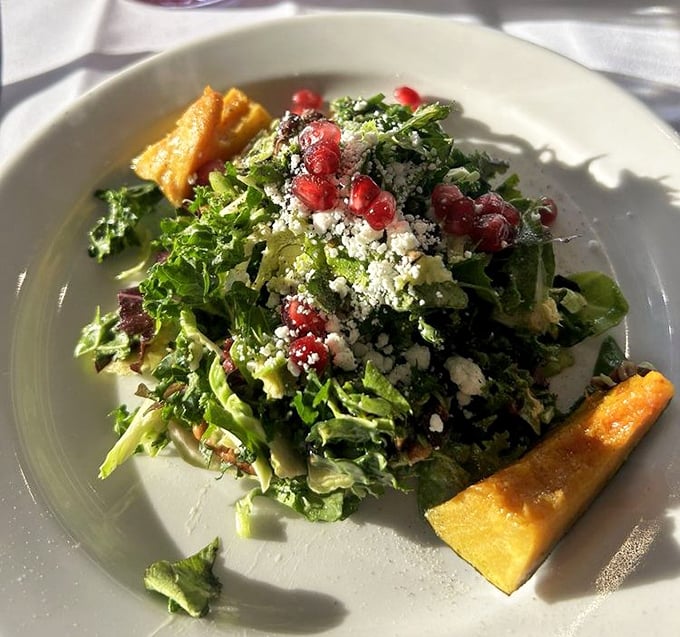 A salad that doesn't apologize for being healthy &ndash; bright greens, pomegranate jewels, and cheese that makes eating vegetables feel like cheating.