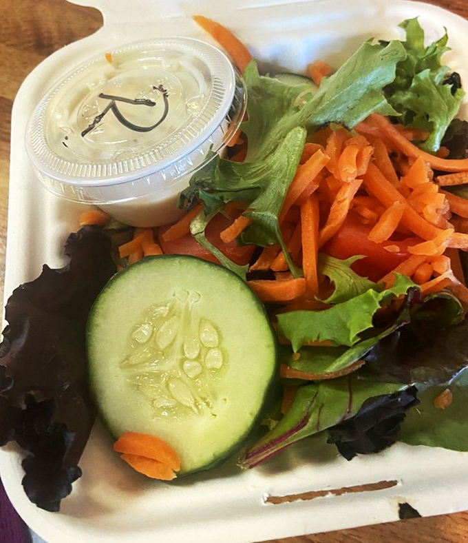 Even the side salad gets special attention here, with fresh cucumber, crisp greens, and shredded carrots offering a refreshing counterpoint to seafood indulgence.