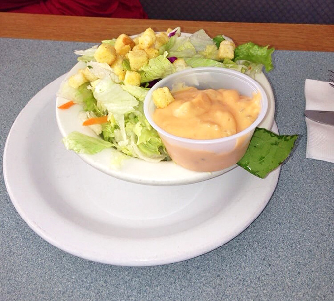 A simple side salad that knows its role&mdash;the token vegetable in a world of indulgence. That thousand island dressing isn't fooling anyone.