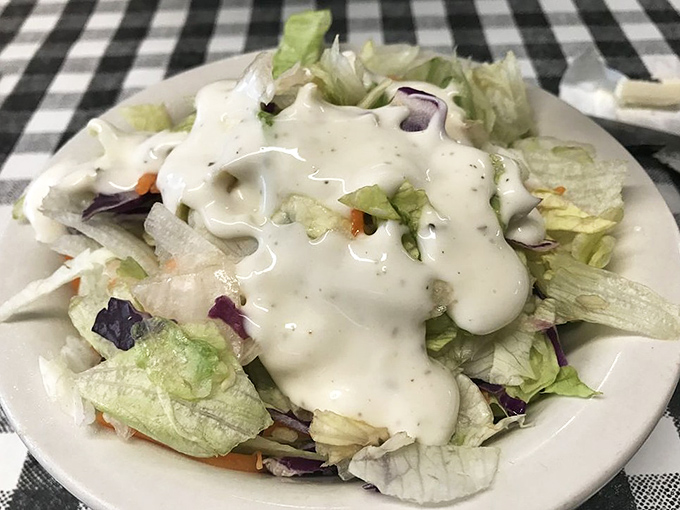 A simple garden salad with house dressing&mdash;because sometimes you need something green before diving into that banana pudding.