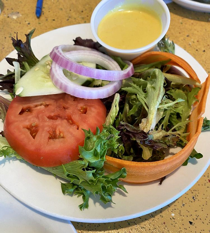 A salad that doesn't apologize for being healthy. Those vibrant veggies and that sunny dressing are having their own little garden party.