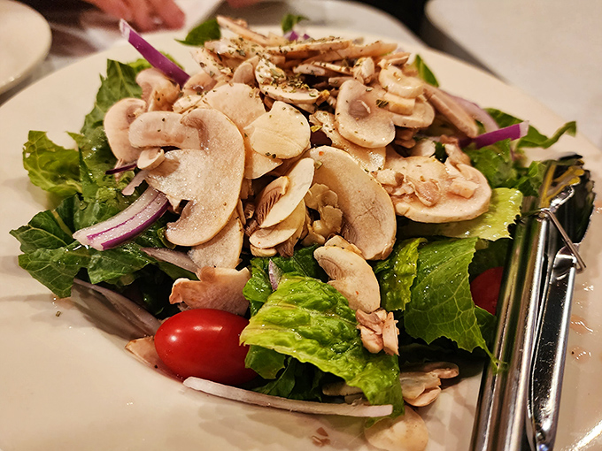 Even the salad gets special treatment with fresh mushrooms, crisp greens, and vibrant tomatoes for those taking a brief break from seafood.