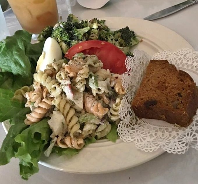A pasta salad that doesn't apologize for being exactly what it is &ndash; fresh, vibrant, and substantial. That doily under the bread is a charming touch of old-school class.