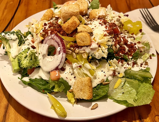 Fresh salad loaded with toppings proves that even carnivore temples know how to treat their greens with respect.