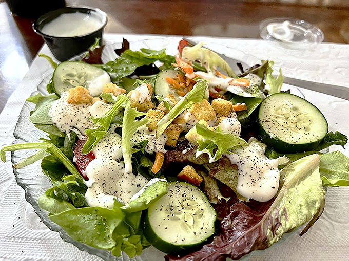 A salad this fresh deserves respect&mdash;crisp greens, cucumber slices, and house-made dressing prove vegetables aren't just an afterthought at Old Salty's.