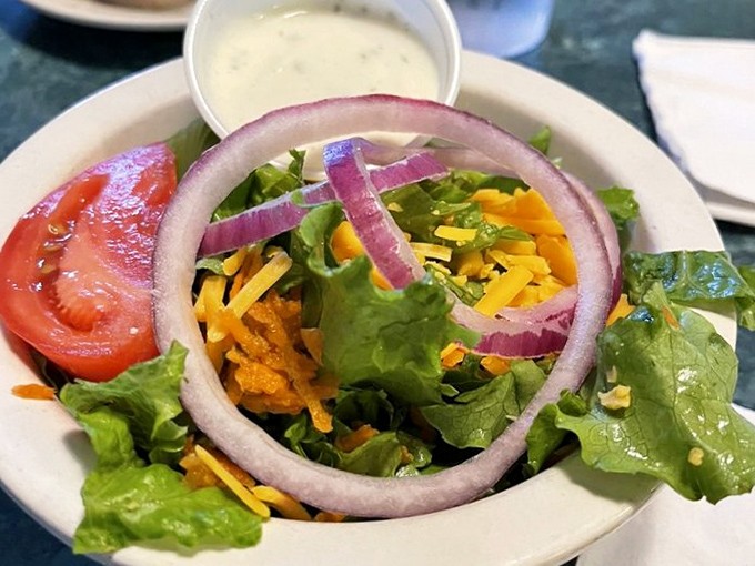 A garden-fresh salad that somehow manages to hold its own in a restaurant famous for comfort food. Balance, friends, balance.