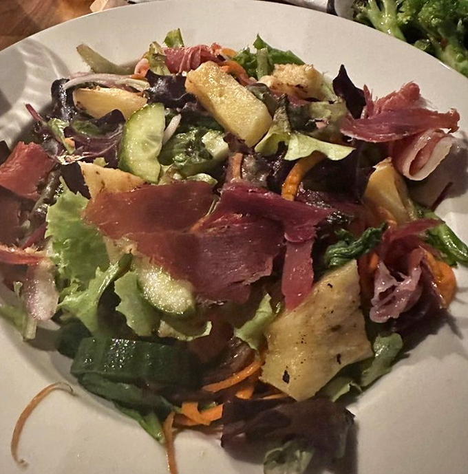 The house salad brings unexpected delight &ndash; fresh, colorful, and substantial enough to make you forget you came for the wings. Almost.