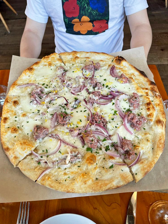 Salsiccia pizza showcasing the beautiful marriage of house-made sausage and red onion. Some relationships are just meant to be.