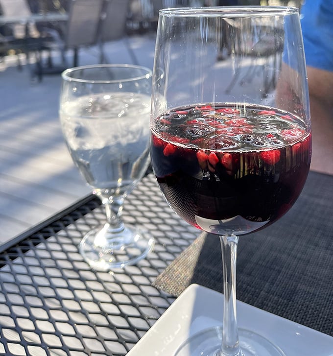 Wine on the outdoor patio &ndash; where sangria's deep ruby glow promises relaxation as reliable as Florida's afternoon sunshine.